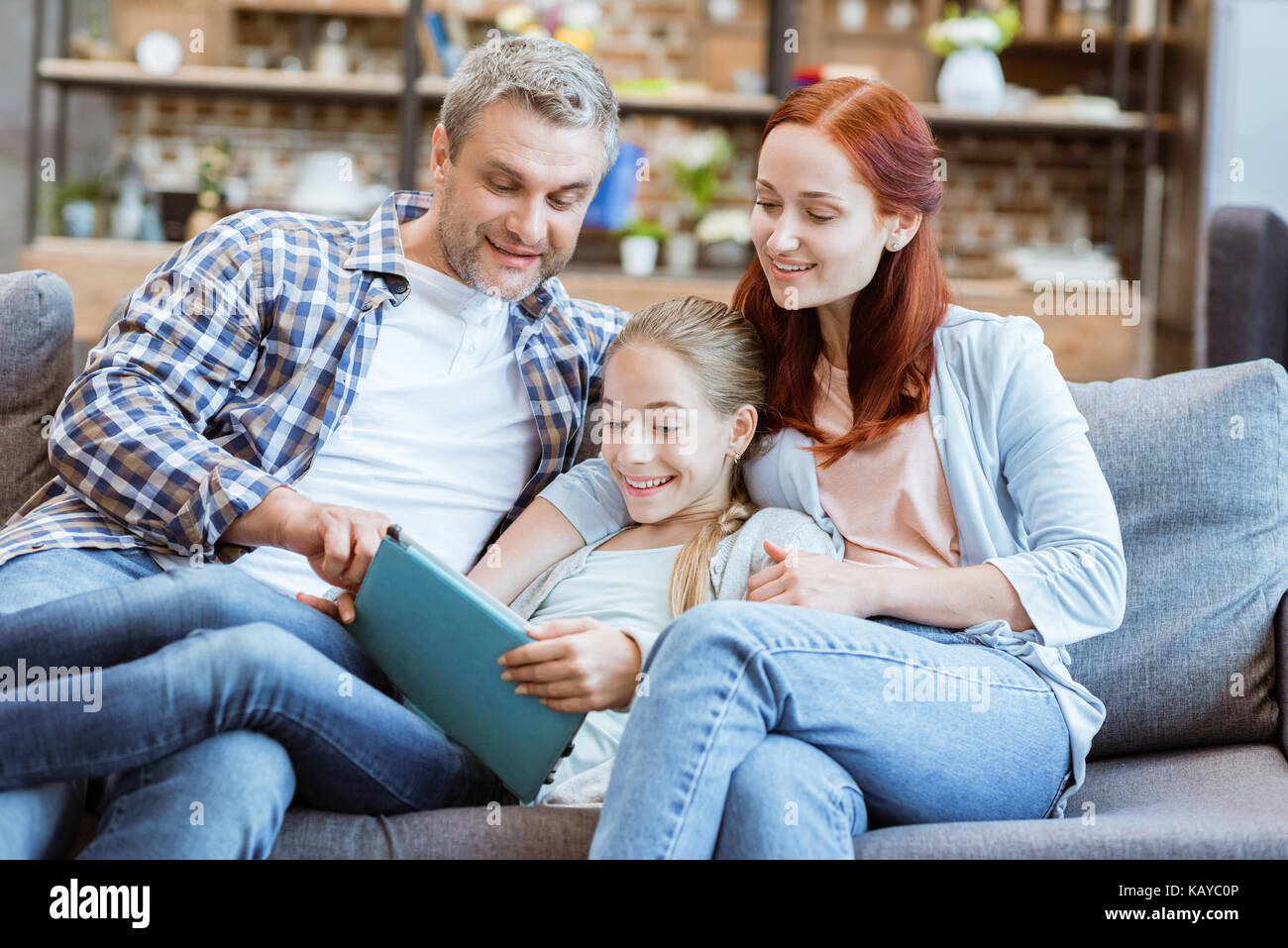 family using tablet Stock Photo - Alamy