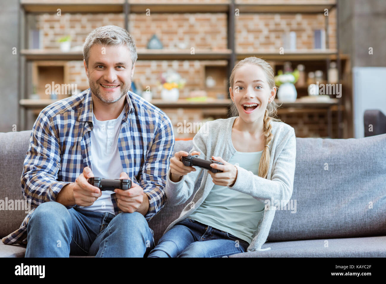 father and daughter playing video game Stock Photo - Alamy