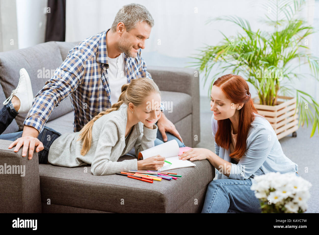 parents helping teenager with homework Stock Photo - Alamy