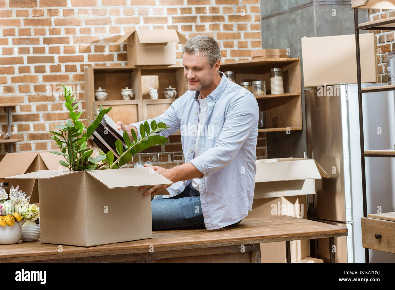 man unpacking boxes Stock Photo - Alamy