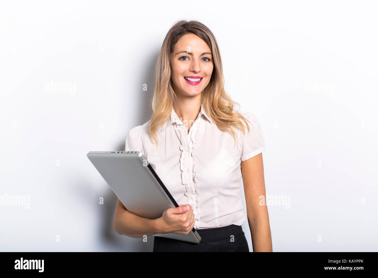 Young business woman offers computer product, on grey background Stock ...