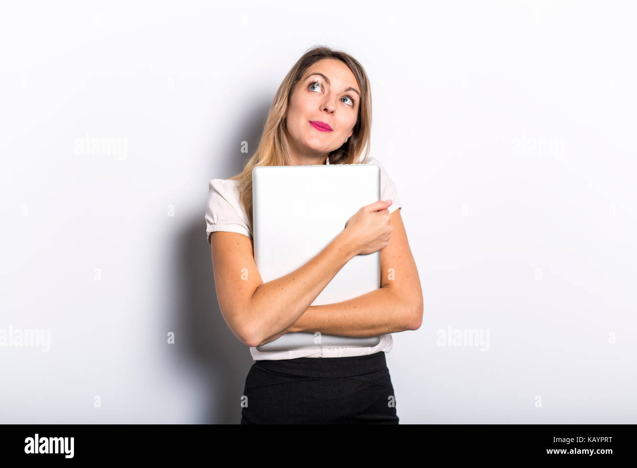 Young business woman offers computer product, on grey background Stock ...