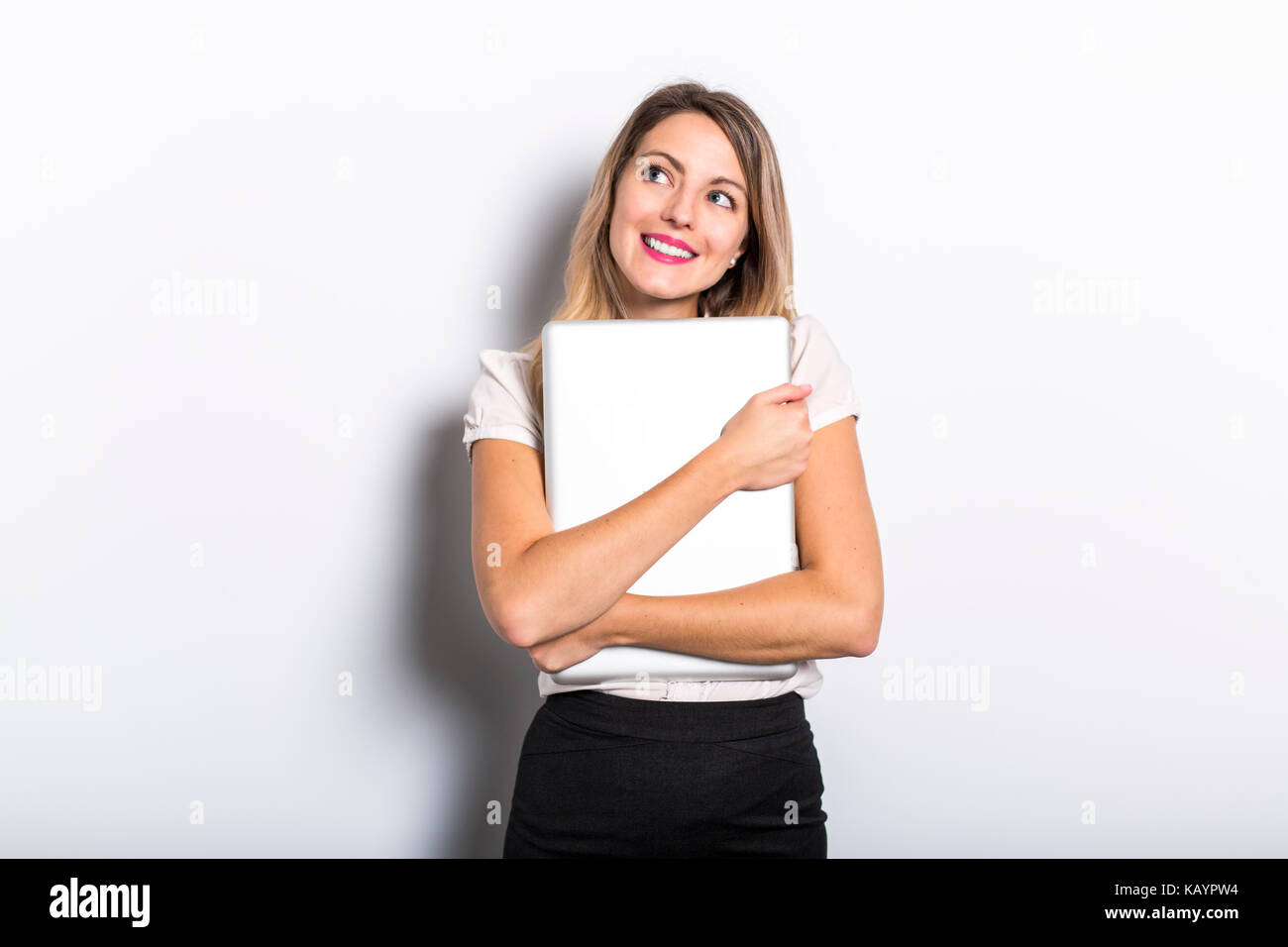 Young business woman offers computer product, on grey background Stock ...