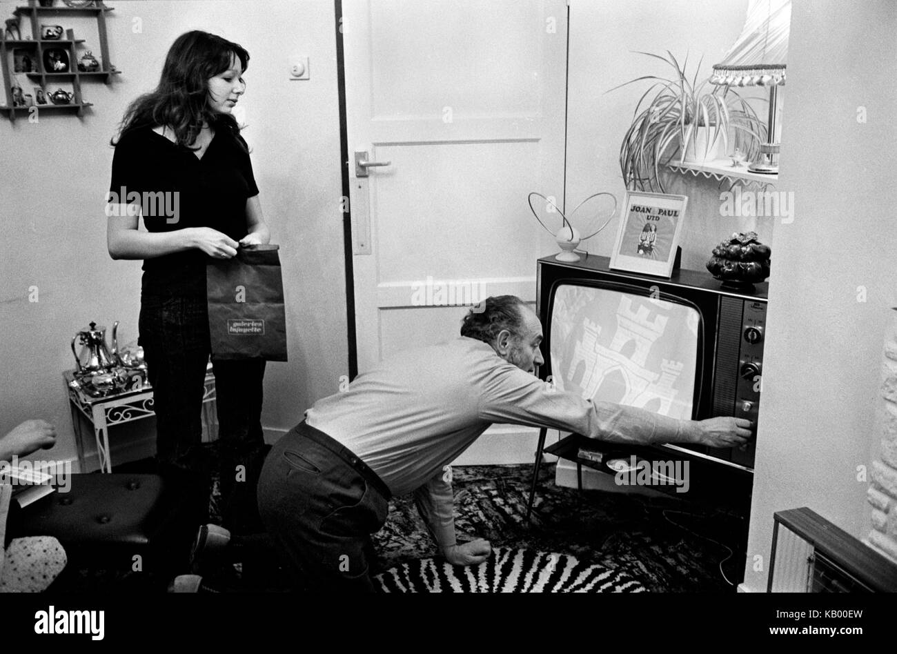Watching TV television 1970s UK. Man tuning changing channels at home ...