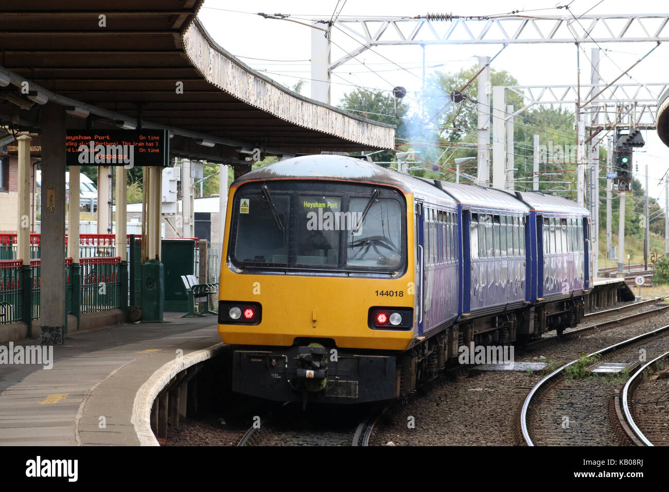 Class 144 Pacer diesel multiple unit setting off from Carnforth railway ...
