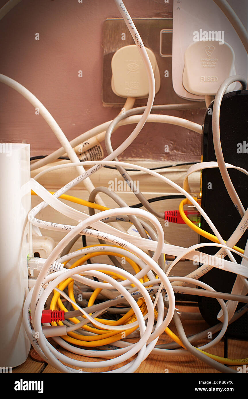 Tangle of wires plugged into a modem and router in the UK Stock Photo ...