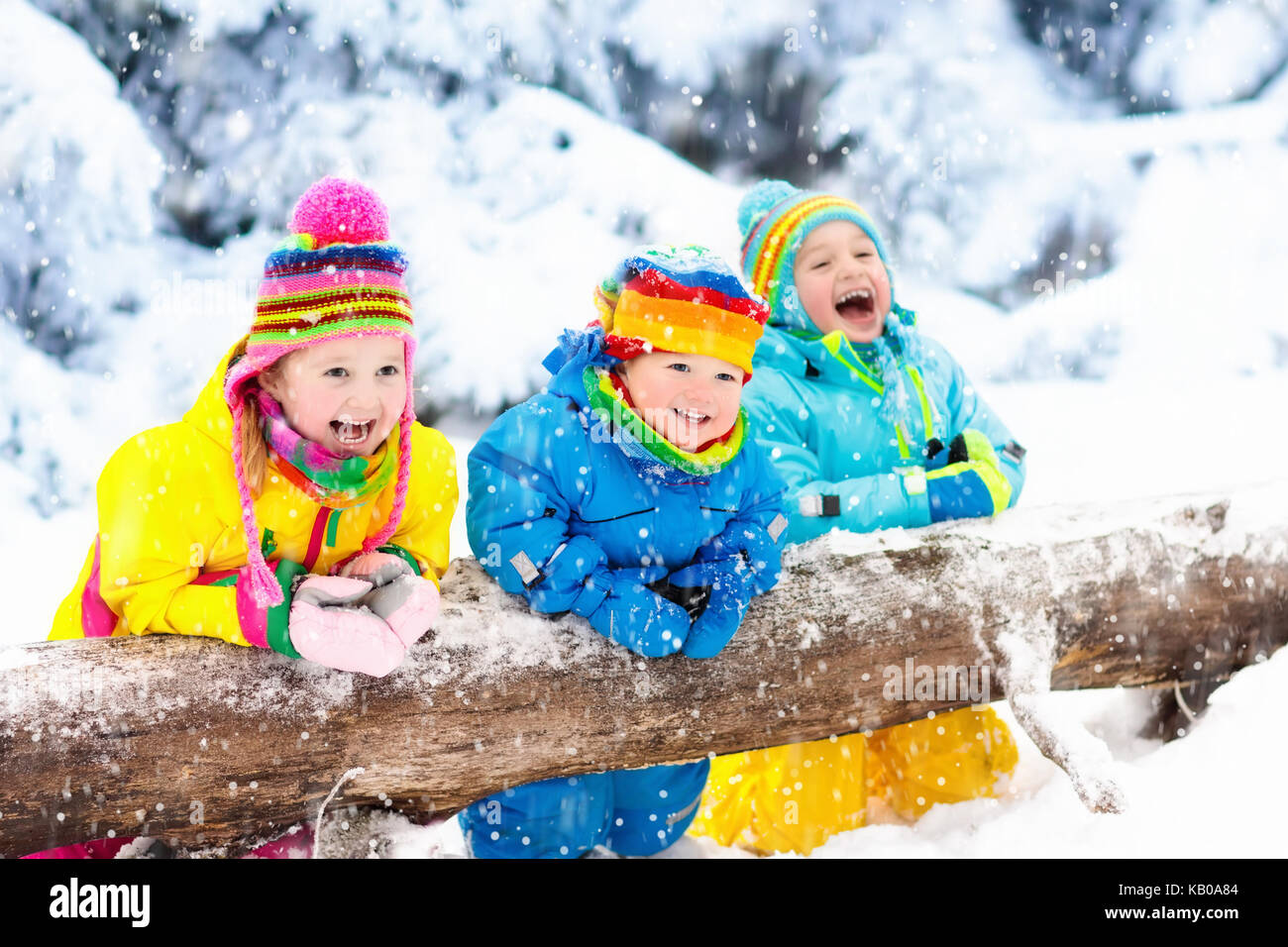 Kids playing in snow. Children play outdoors on snowy winter day. Boy ...