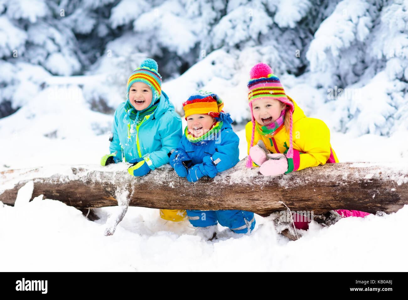 Kids playing in snow. Children play outdoors on snowy winter day. Boy ...