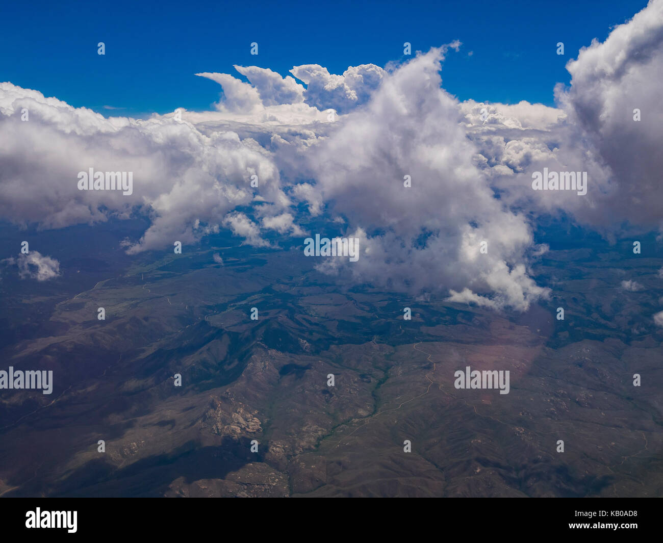 Aerial view of mountain landscape, view from window seat in an airplane ...