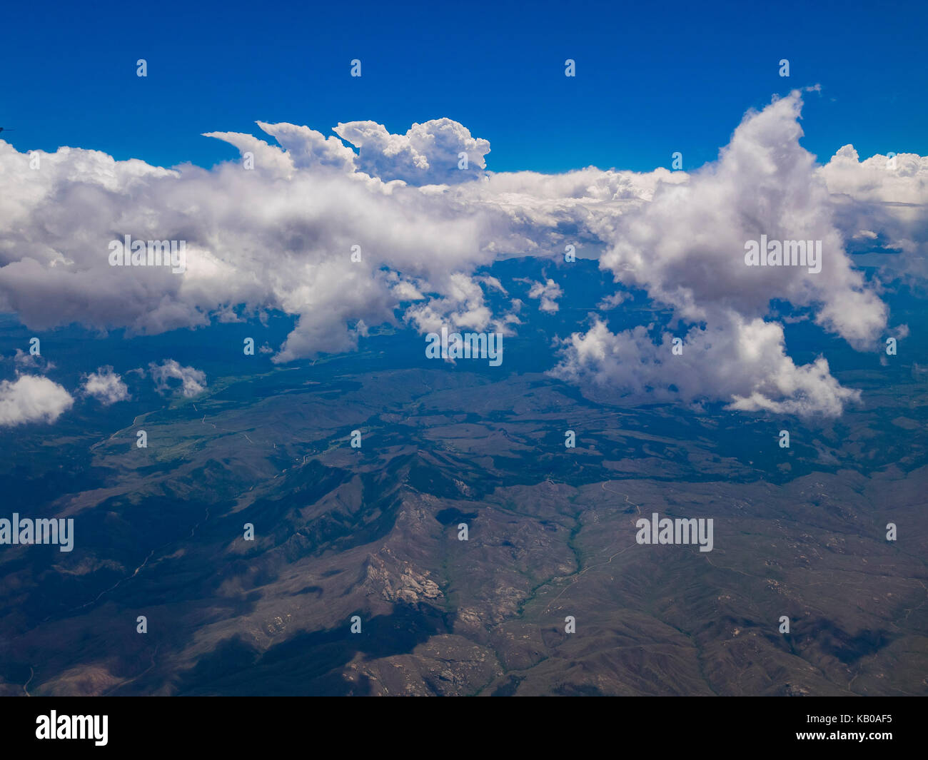 Aerial view of mountain landscape, view from window seat in an airplane ...