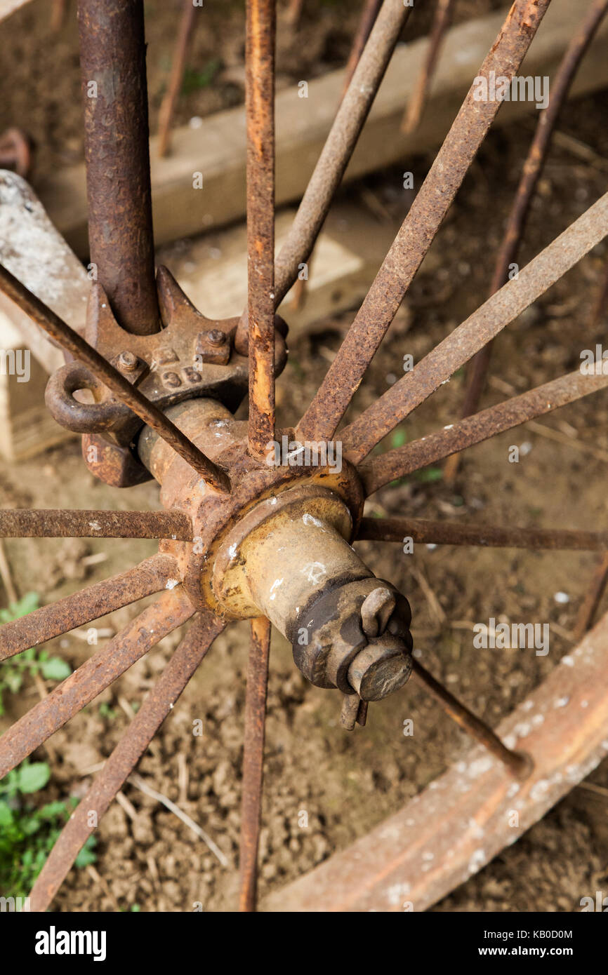 A closeup of the spokes on an old rusty wagon wheel on a farm Stock ...