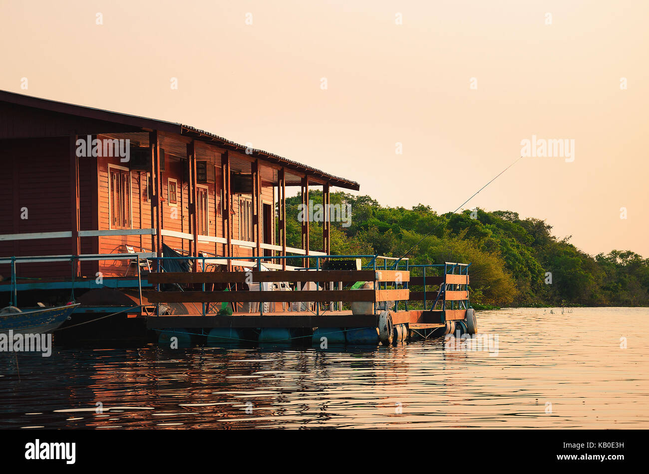 Floating house on the banks of a river in Pantanal, Brazil. Peaceful ...