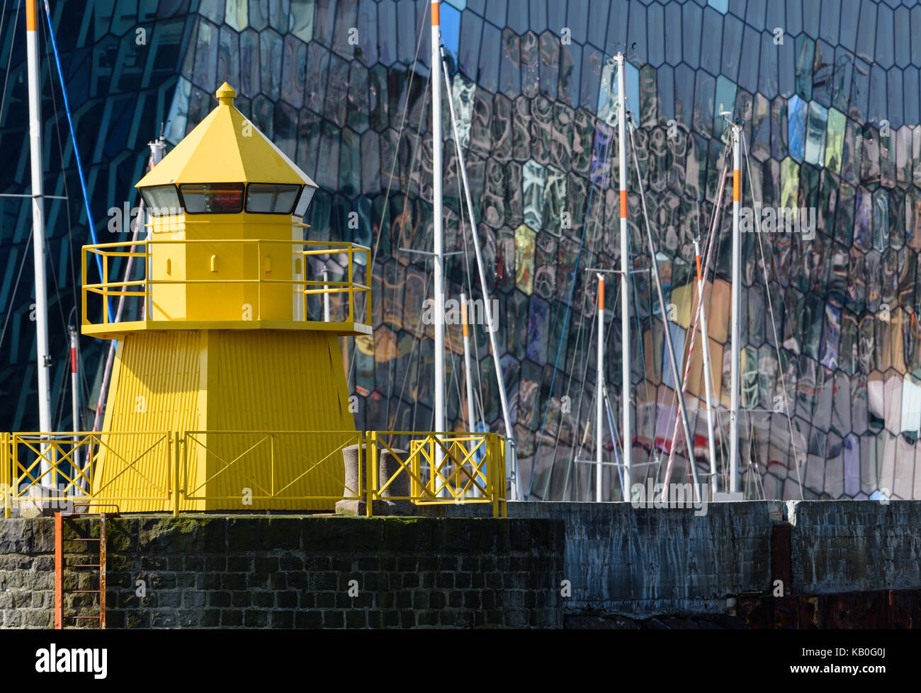 Yellow lighthouse in the Reykjavik, Iceland harbor with colorful and ...
