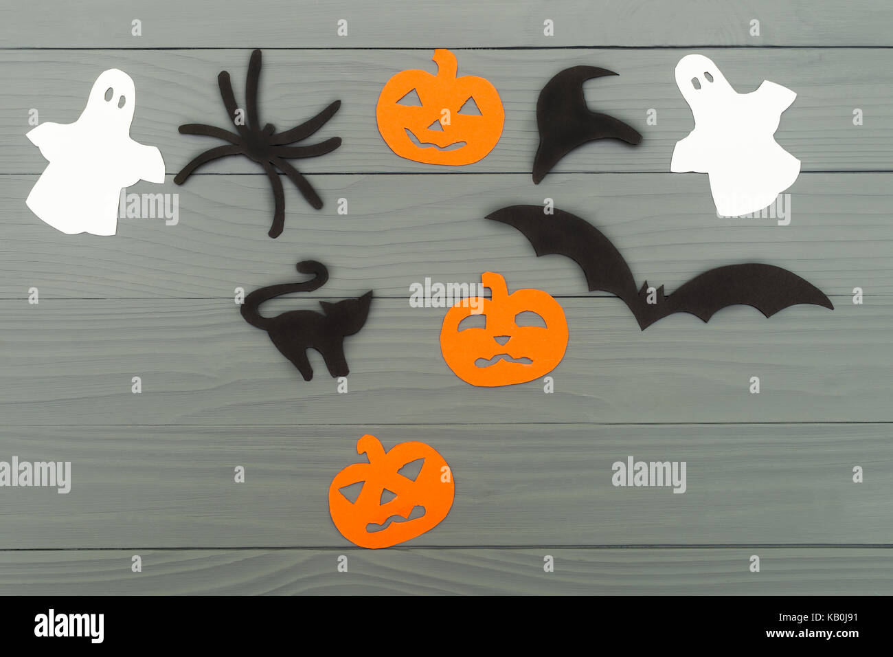 Halloween holiday background with three pumpkins, cat, spider, bat, hat ...