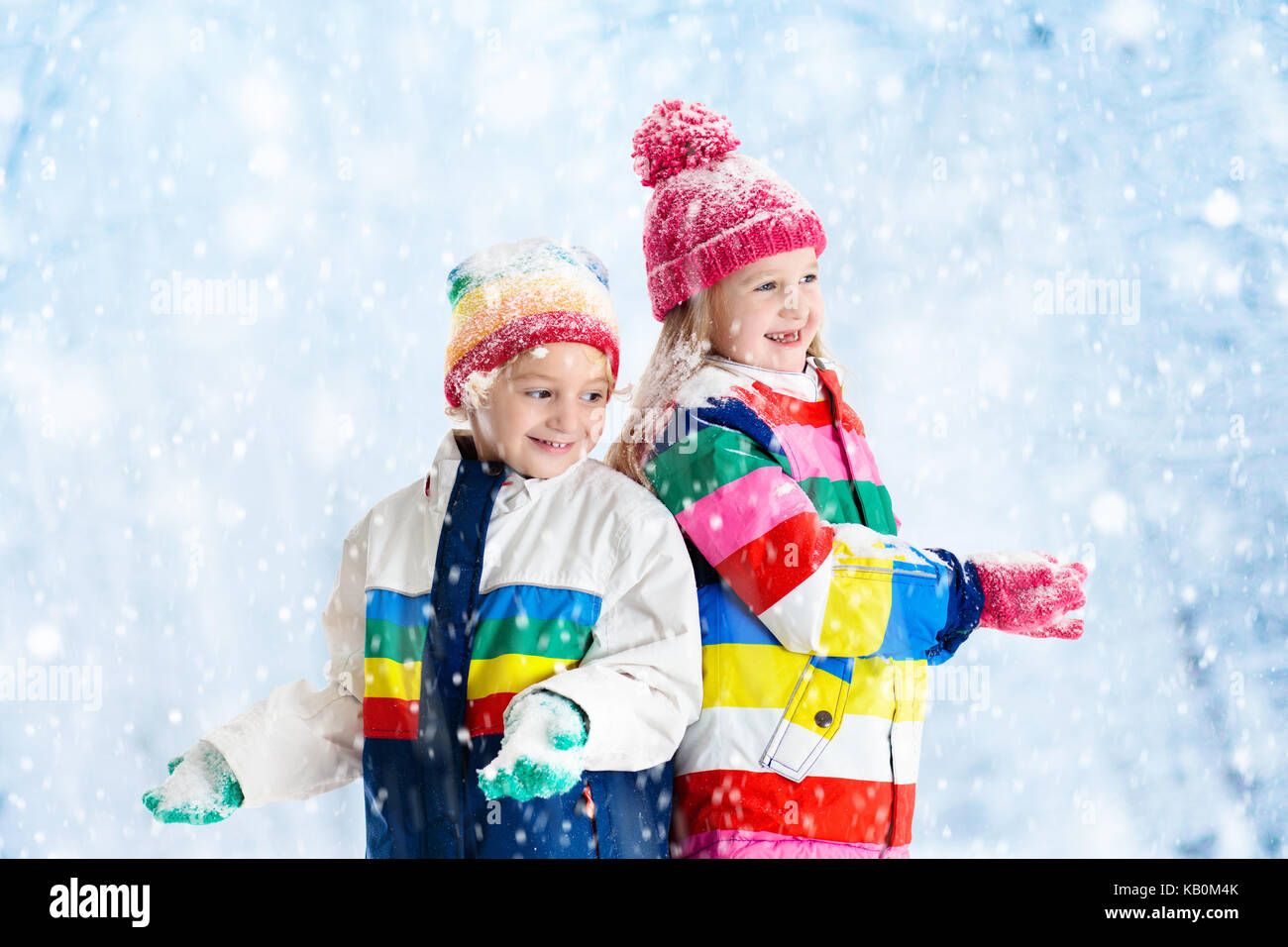 Kids playing in snow. Children play outdoors on snowy winter day. Boy ...