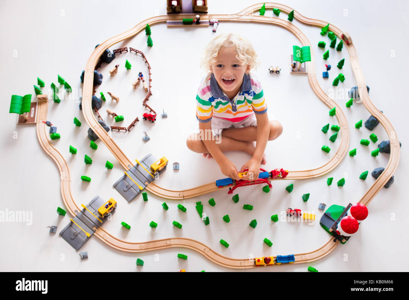 Kids play with toy train railway. Child playing with wooden trains ...