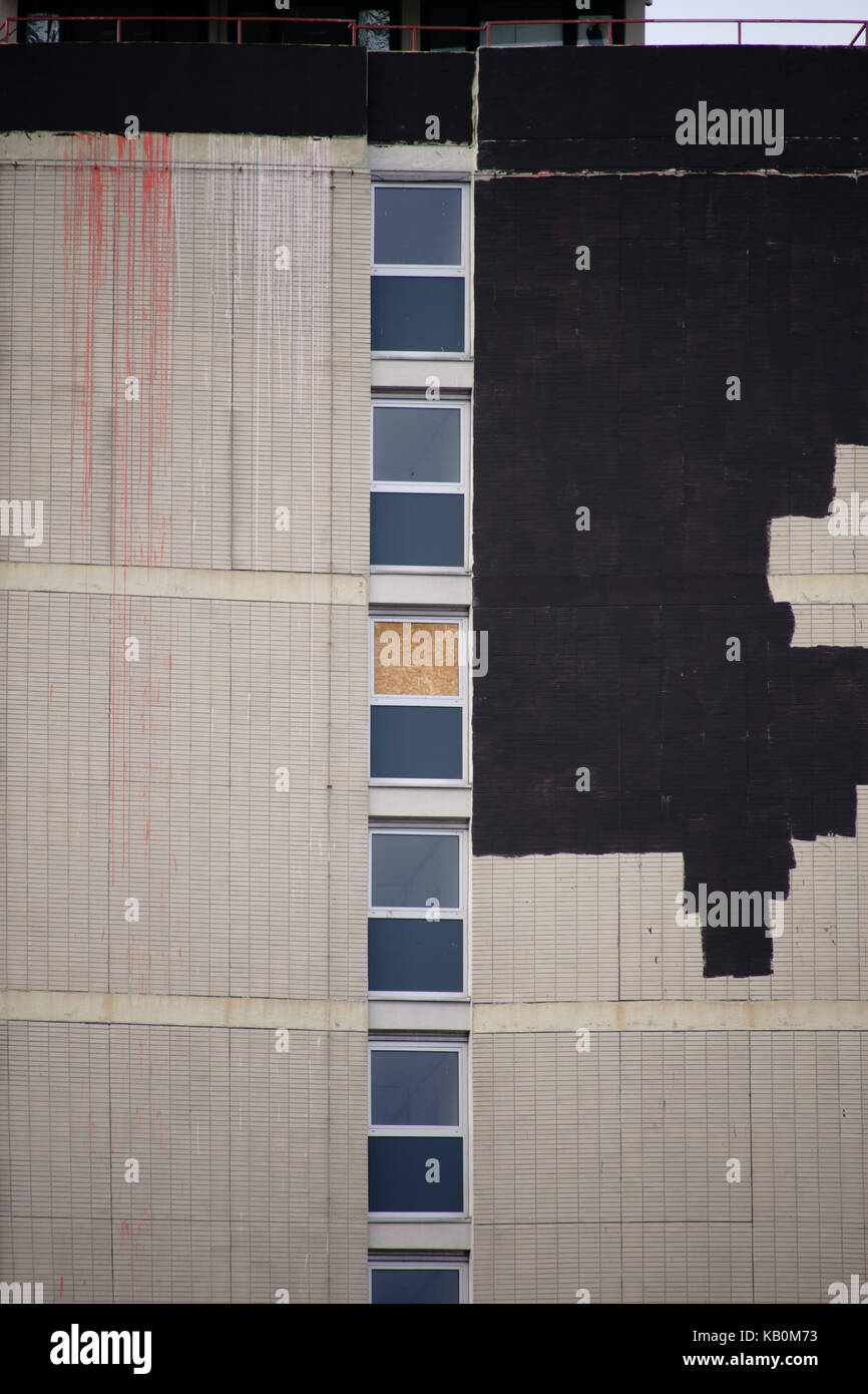 The side view of a high-rise building with tiled facade and color ...