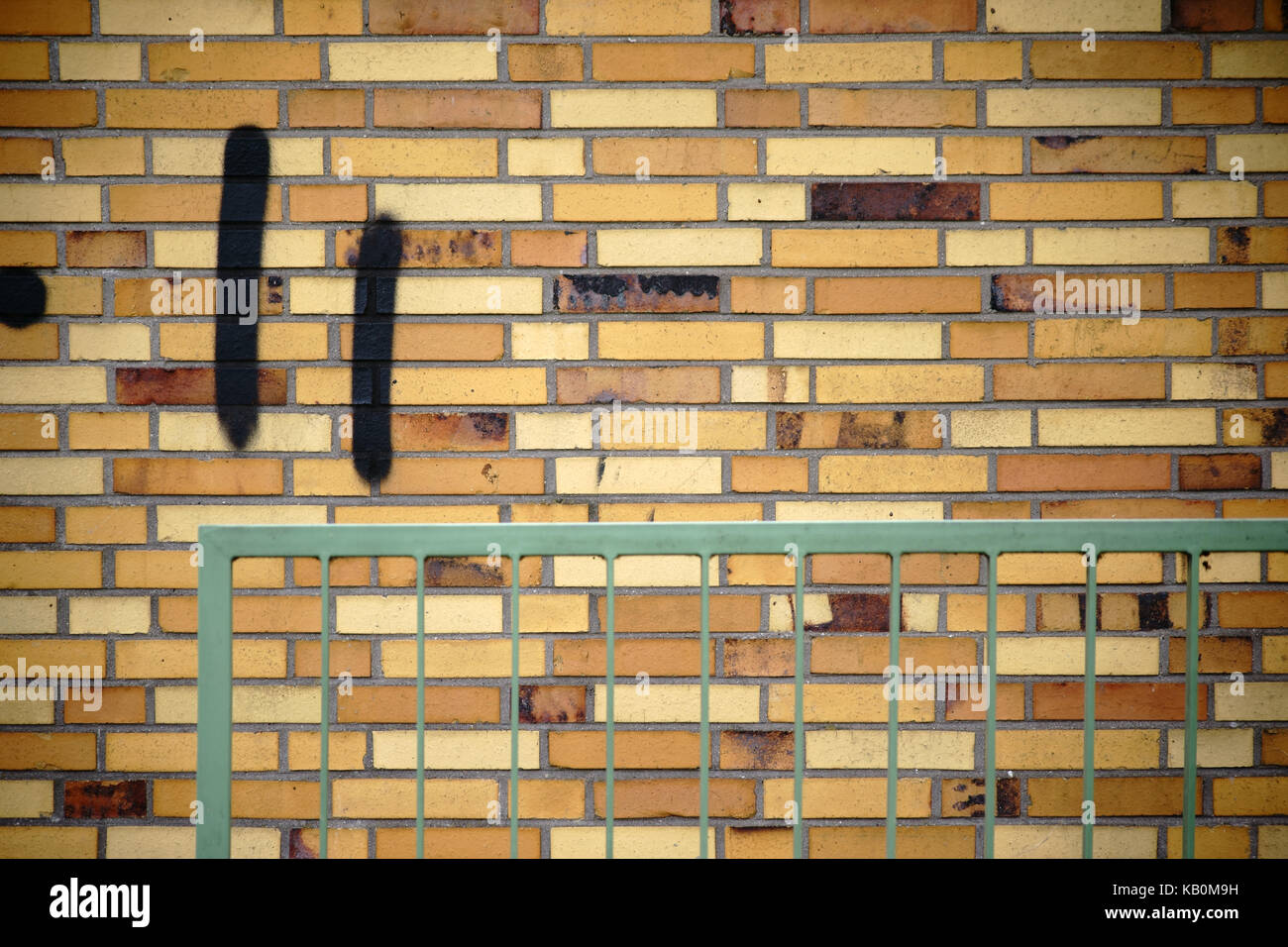 A wall of old clinker bricks with an angular railing in front Stock ...