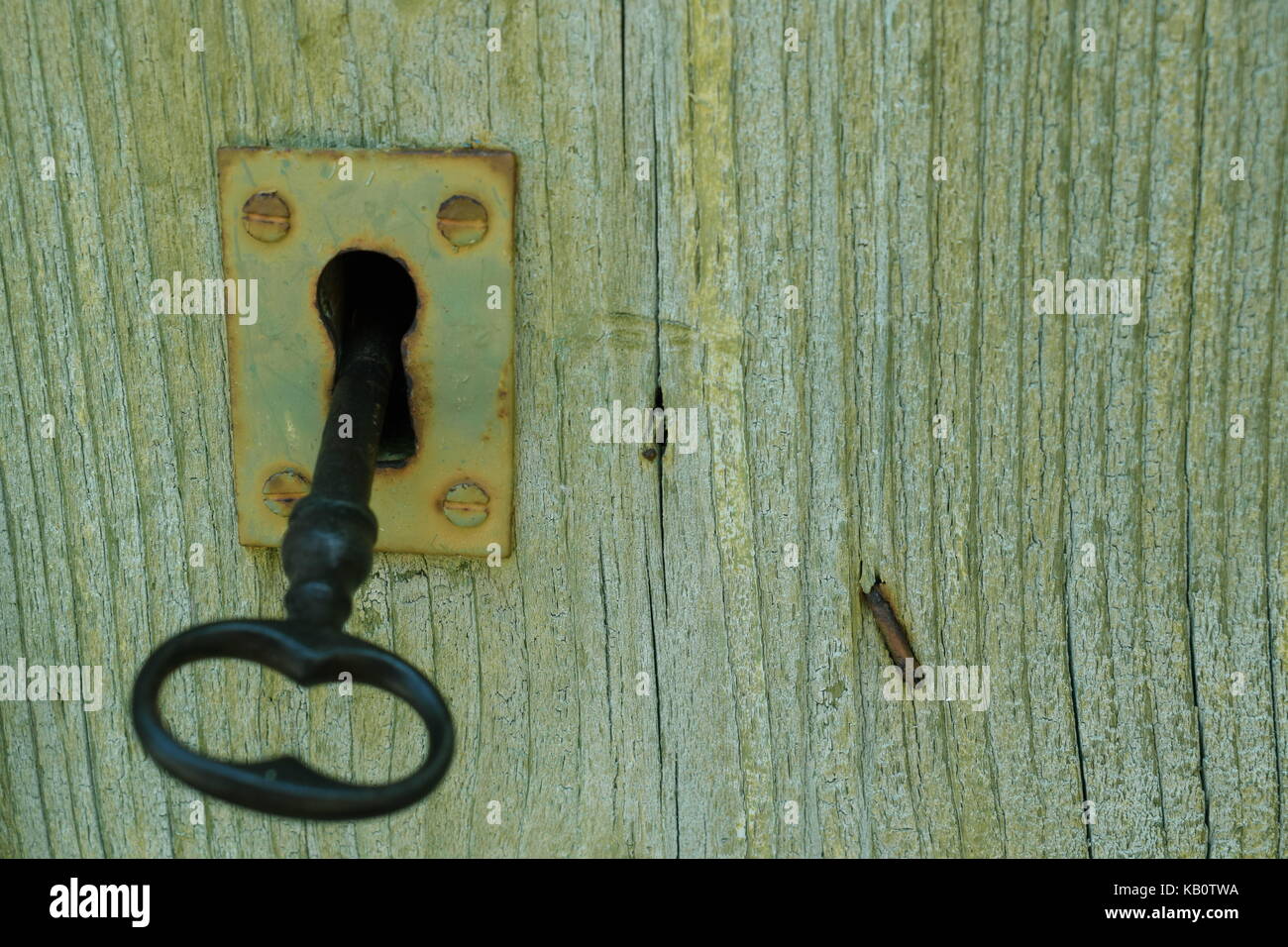Skeleton key at an old wooden door Stock Photo - Alamy