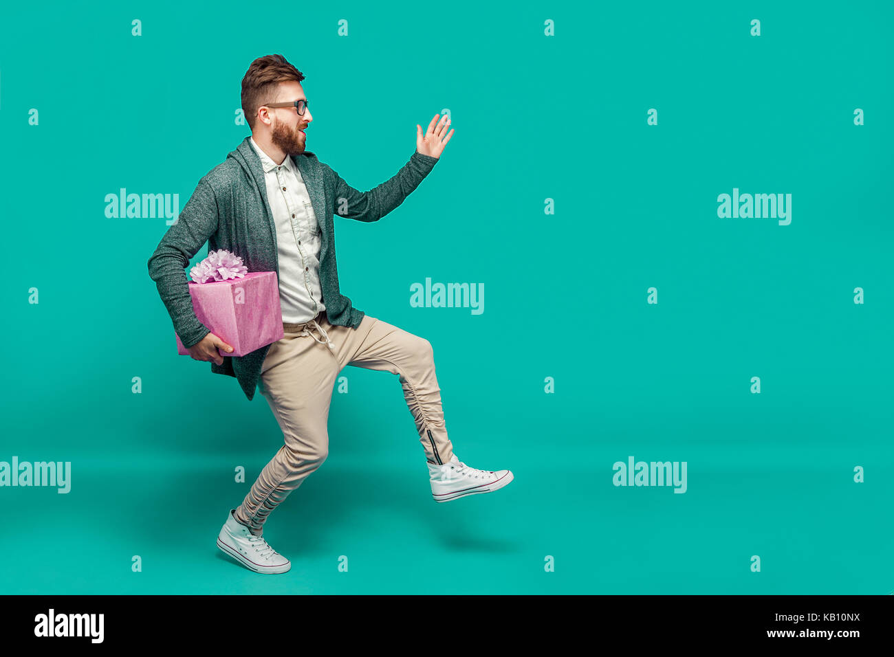 Male posing comically with gift box Stock Photo - Alamy