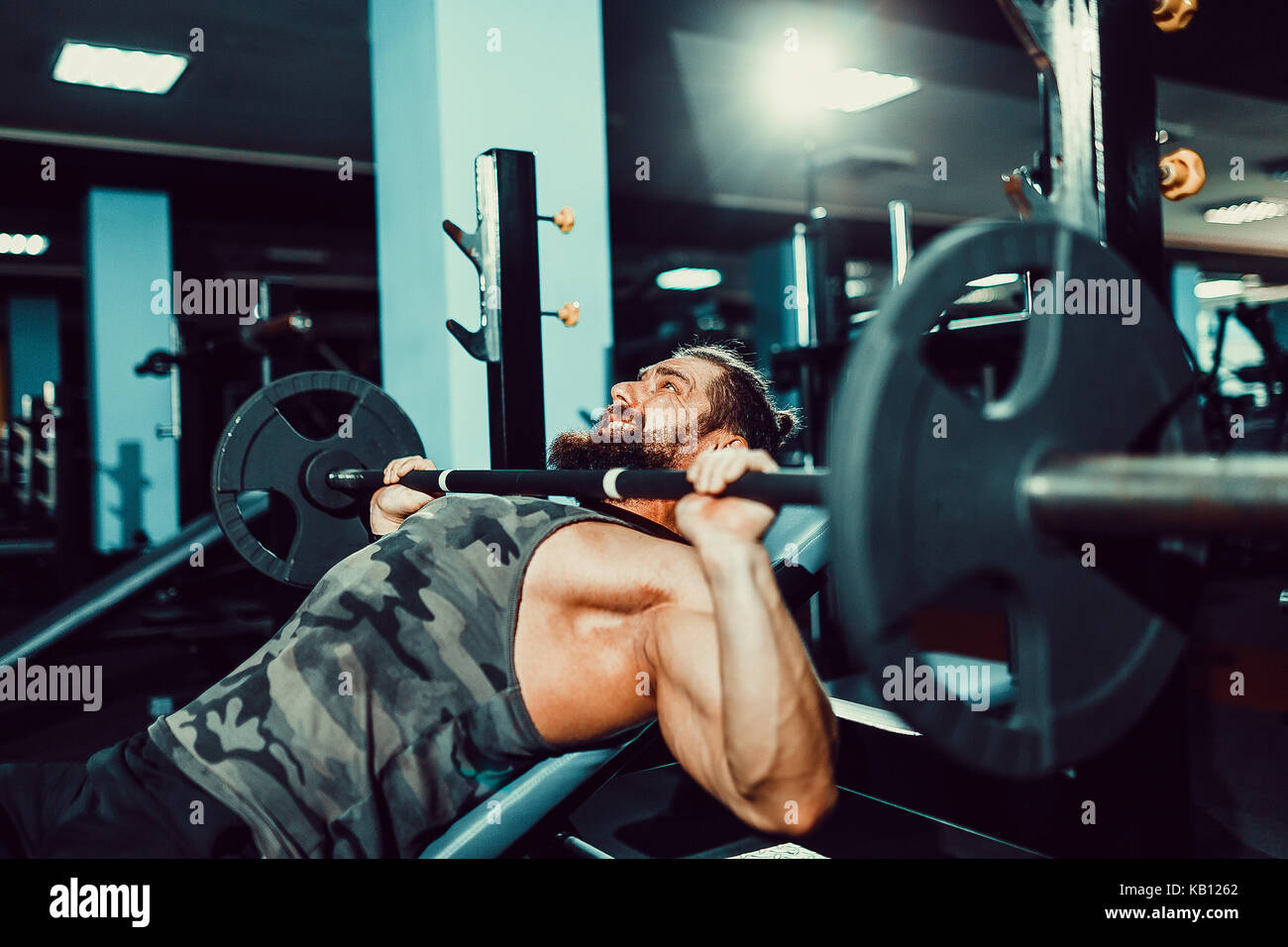 handsome young man doing bench press workout in gym Stock Photo - Alamy