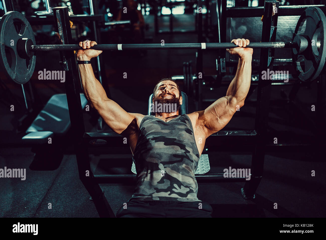handsome young man doing bench press workout in gym Stock Photo - Alamy