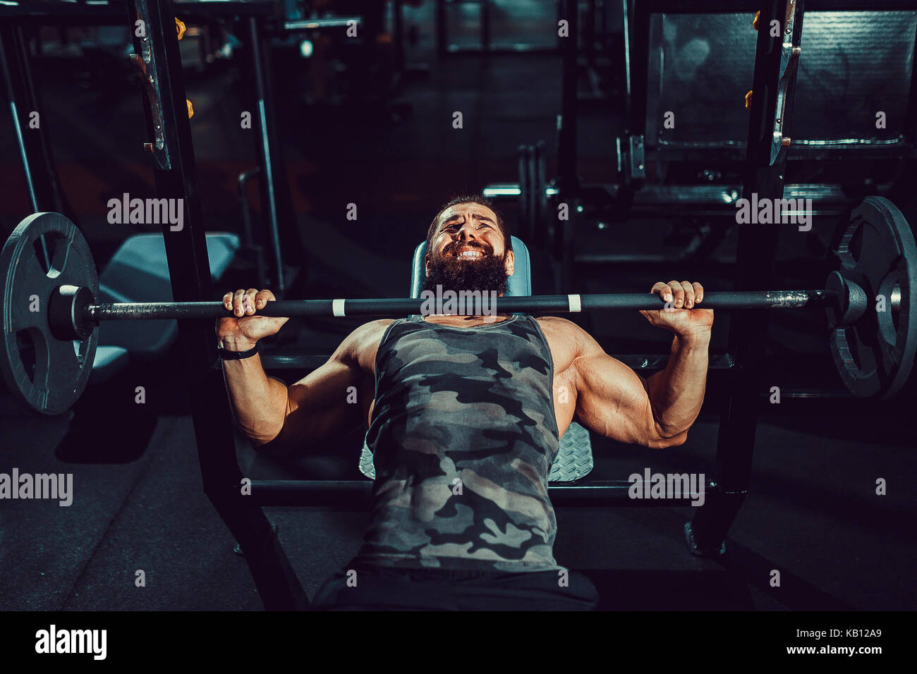 handsome young man doing bench press workout in gym Stock Photo - Alamy