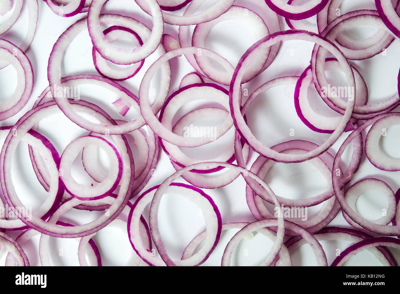 Purple onion raw slices on white background Stock Photo - Alamy