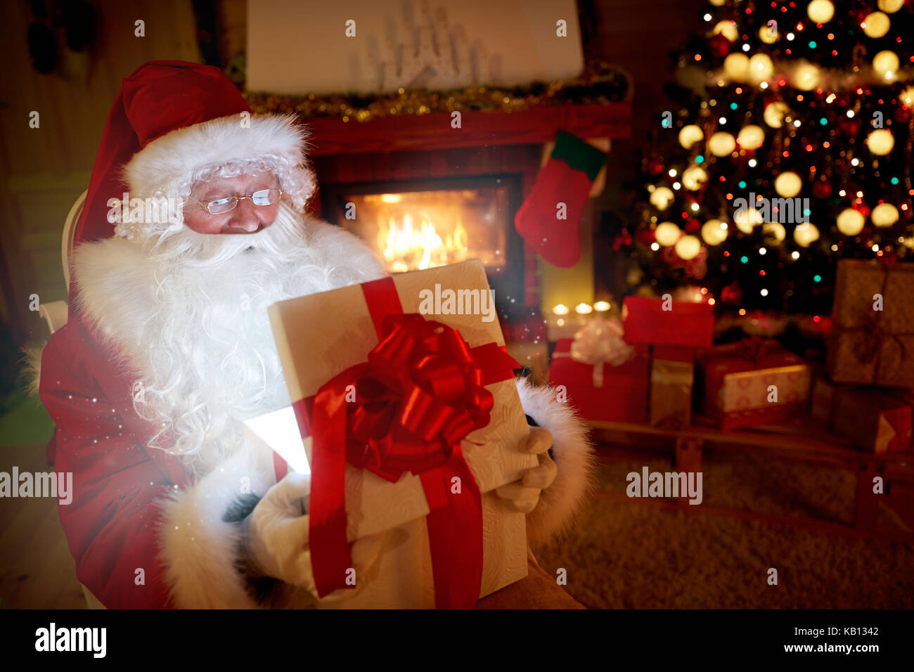 Santa Claus opening a magic gift box and let out atmosphere of a ...