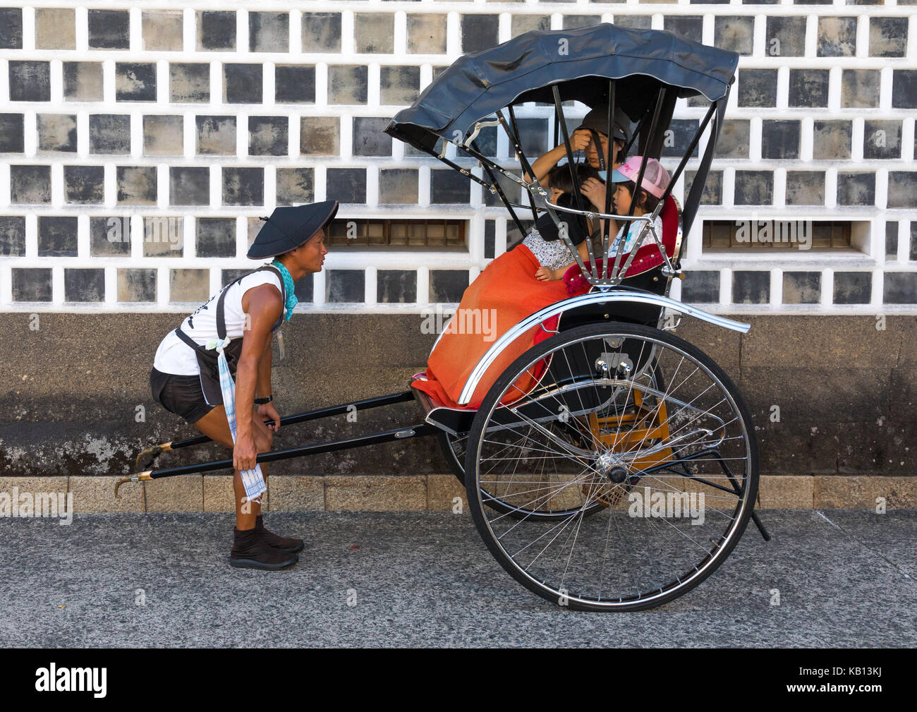 Rickshaw driver taking a picture of tourists in bikan historical ...