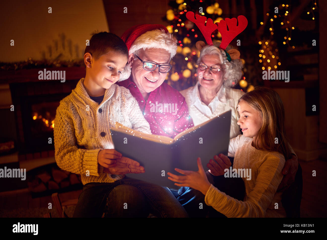 Christmas magic book and happy family Stock Photo - Alamy