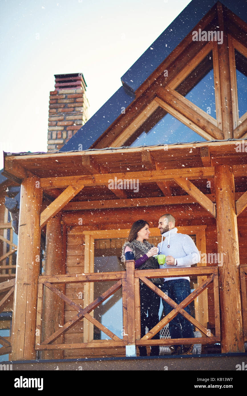 Couple on terrace of mountain house Stock Photo - Alamy