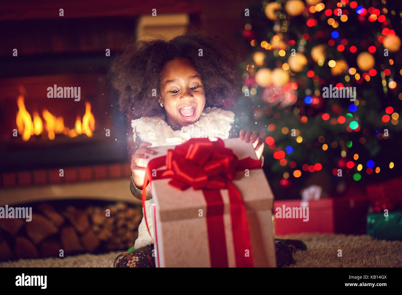 surprise girl opening Christmas magic presents Stock Photo - Alamy