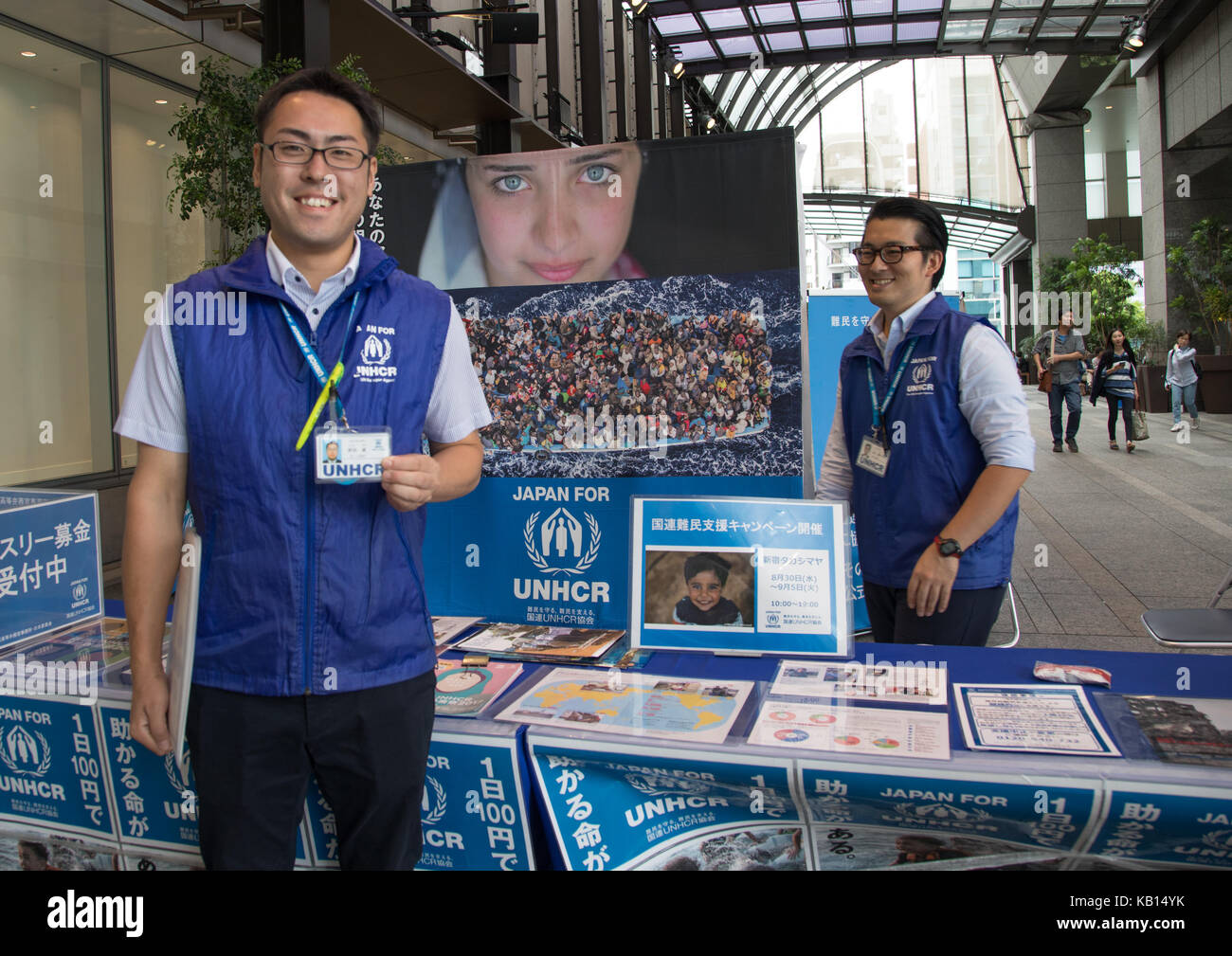 Unhcr charity volunteers on street collecting money for refugees, Kanto ...