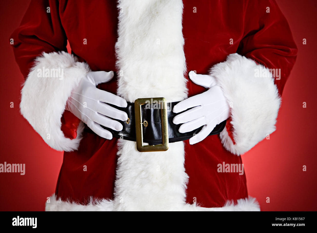 Anonymous Santa Claus on a red background holding various props, gifts ...