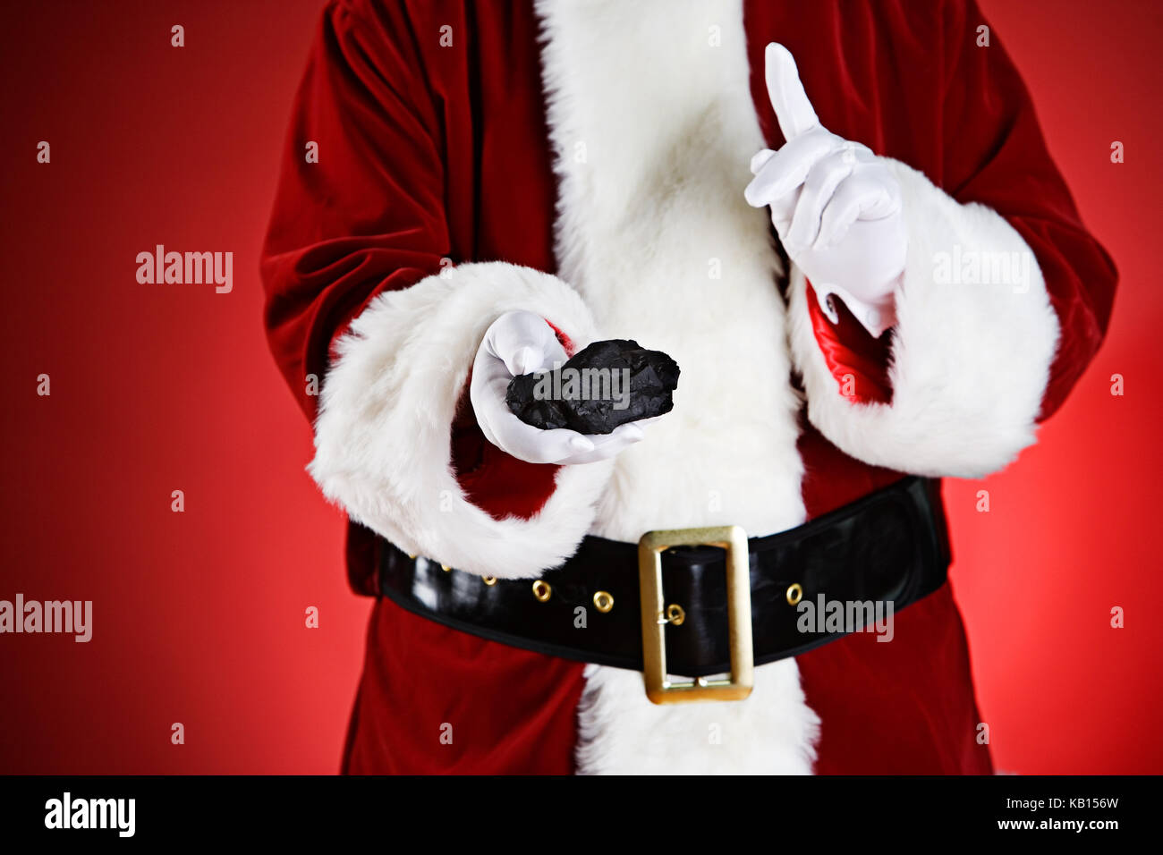 Anonymous Santa Claus on a red background holding various props, gifts ...