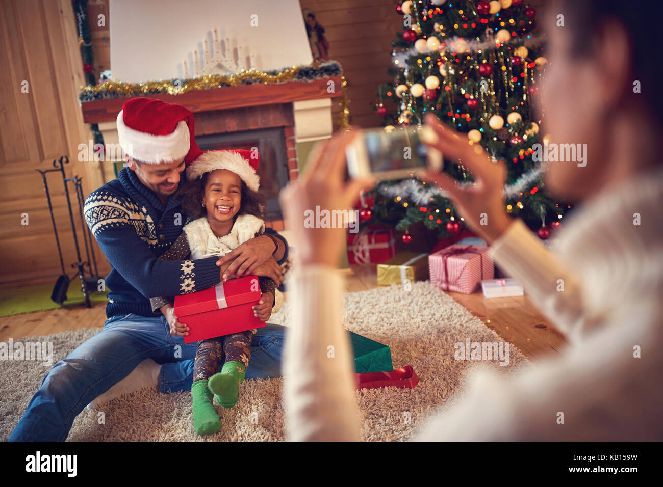 Mother making photo with smart phone of daddy and little daughter Stock ...
