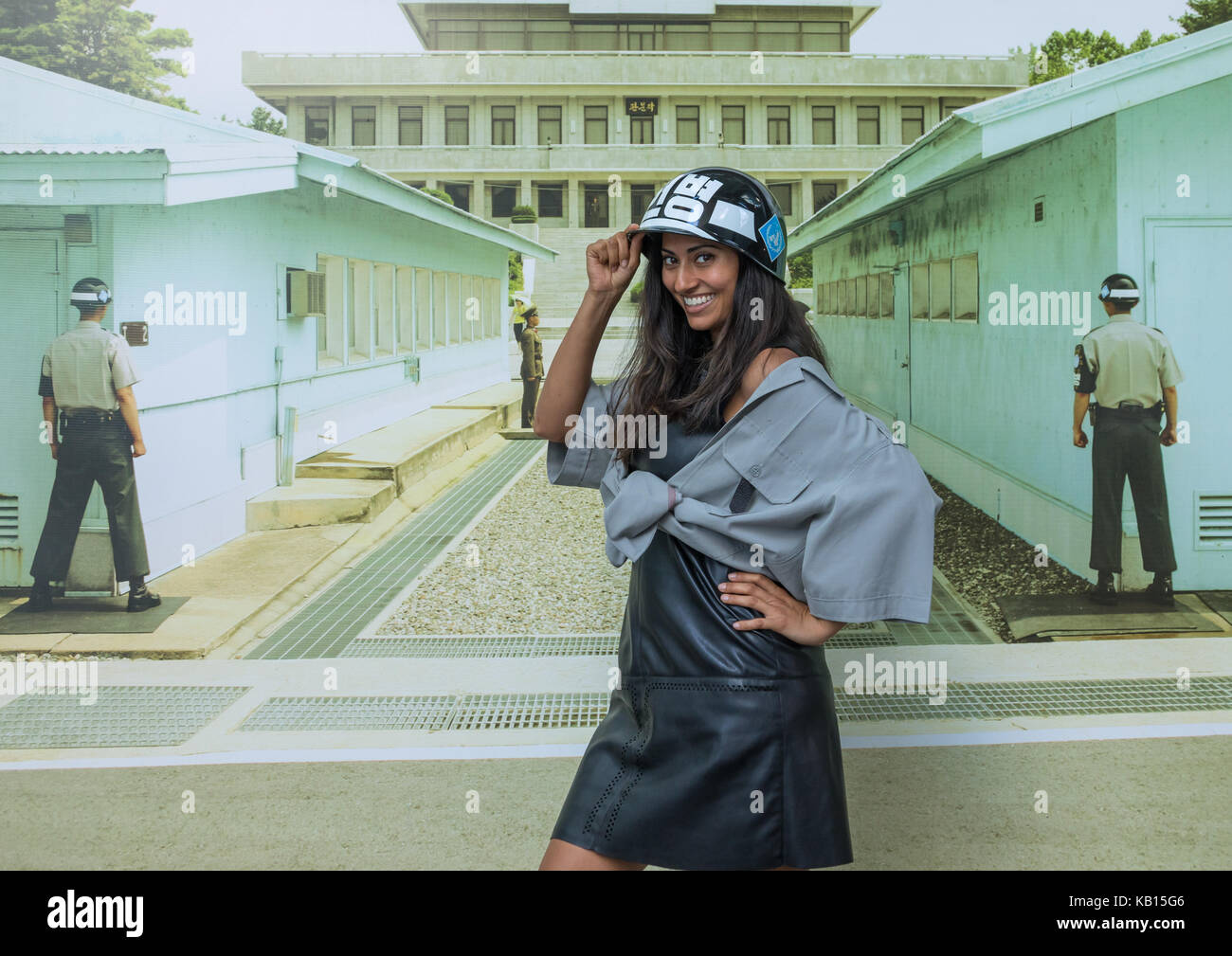 Tourist posing in front of a giant picture of the dmz border, North ...