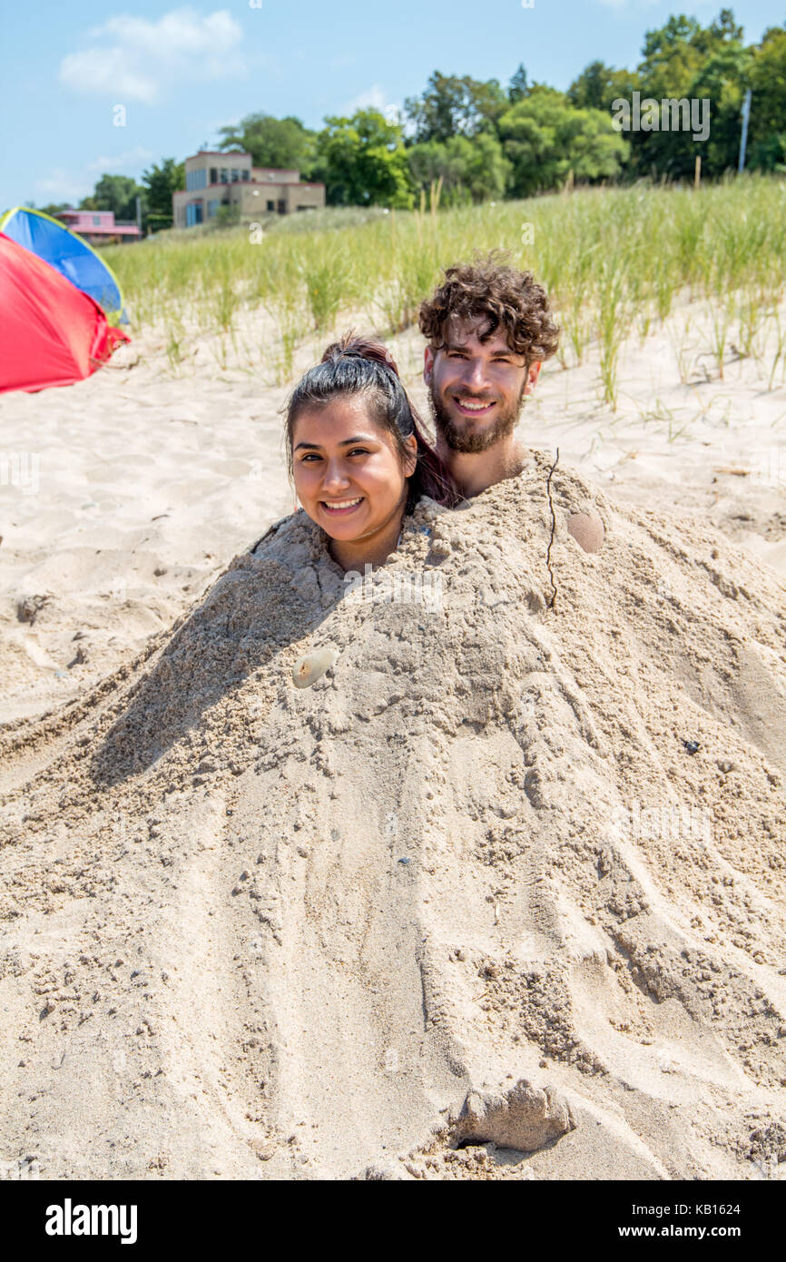 Couple buried in sand hi-res stock photography and images - Alamy