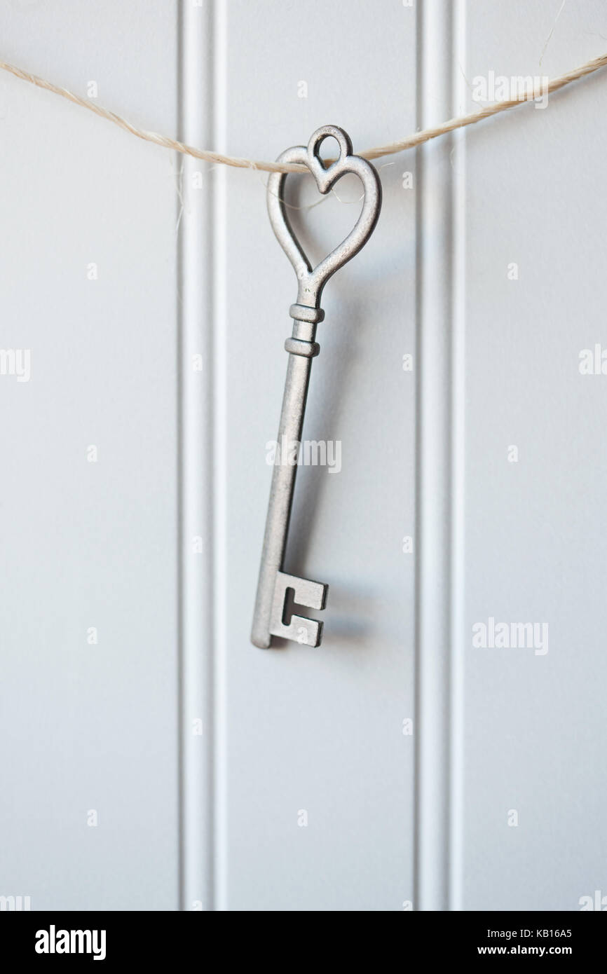 Old metal key with heart shaped end Stock Photo - Alamy