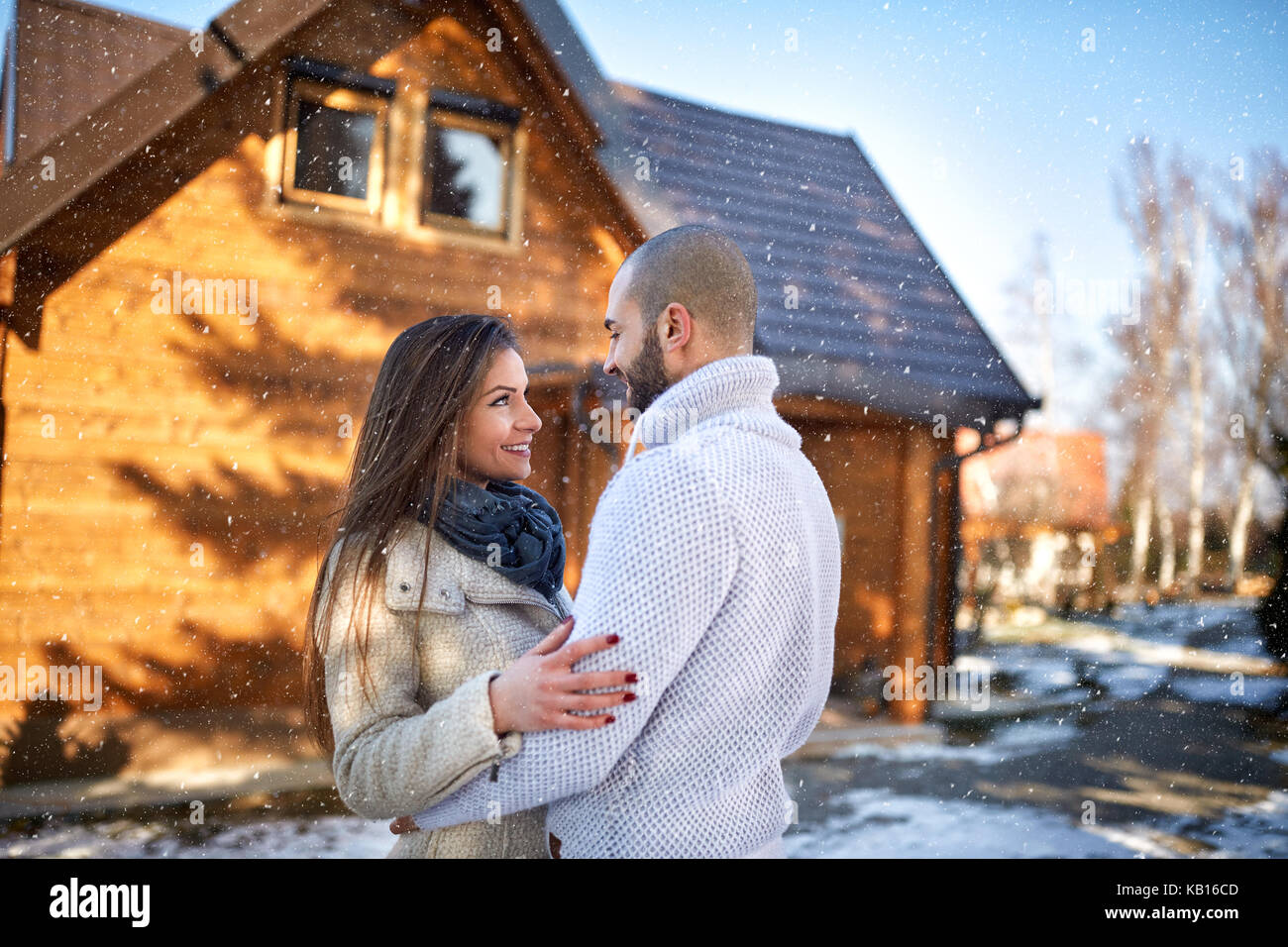 Nice couple in love in front of mountain house Stock Photo - Alamy