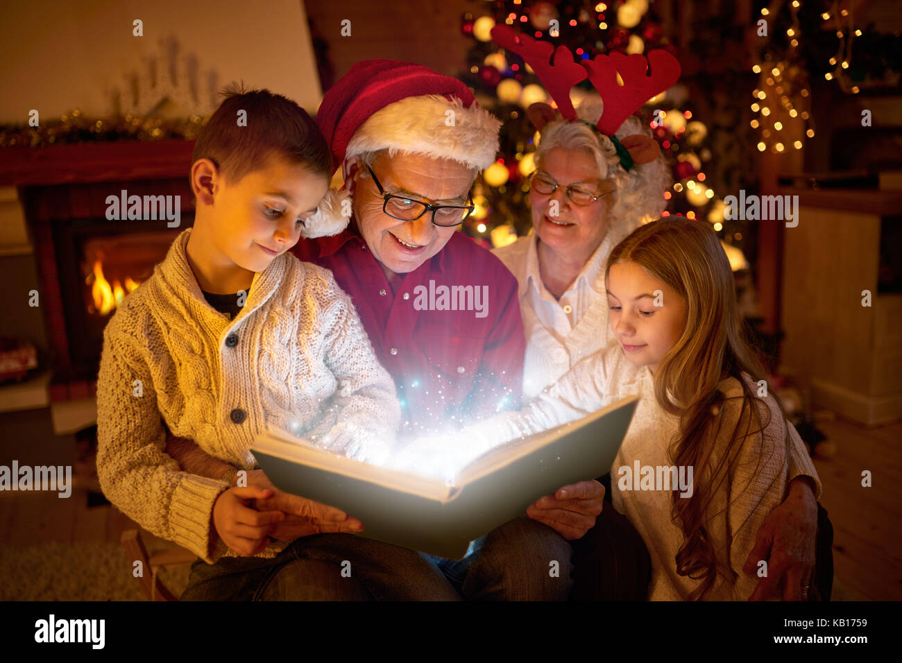 Christmas- family reading magic book Stock Photo - Alamy
