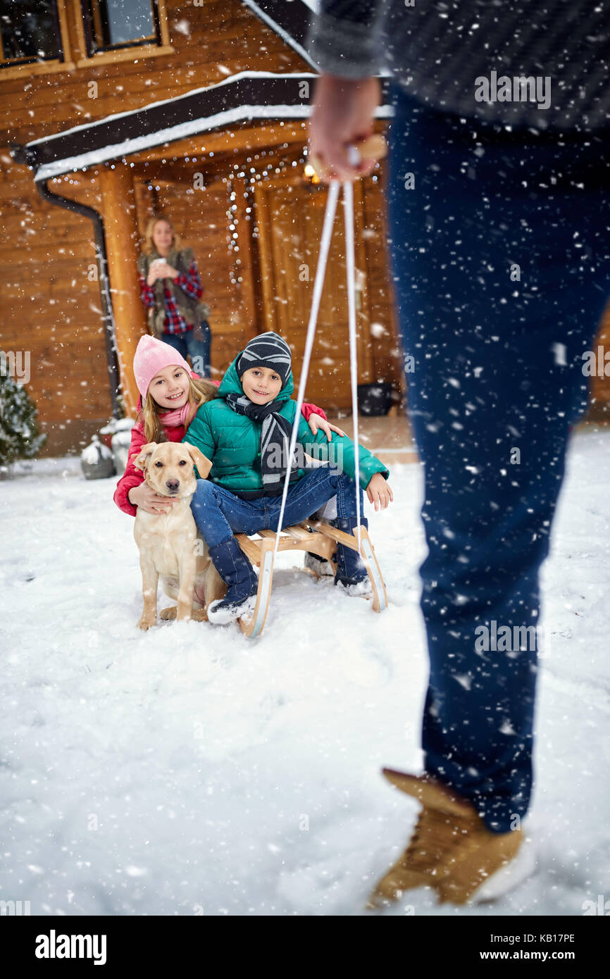 Winter, snow, family sledding at winter time- Family enjoying Stock ...