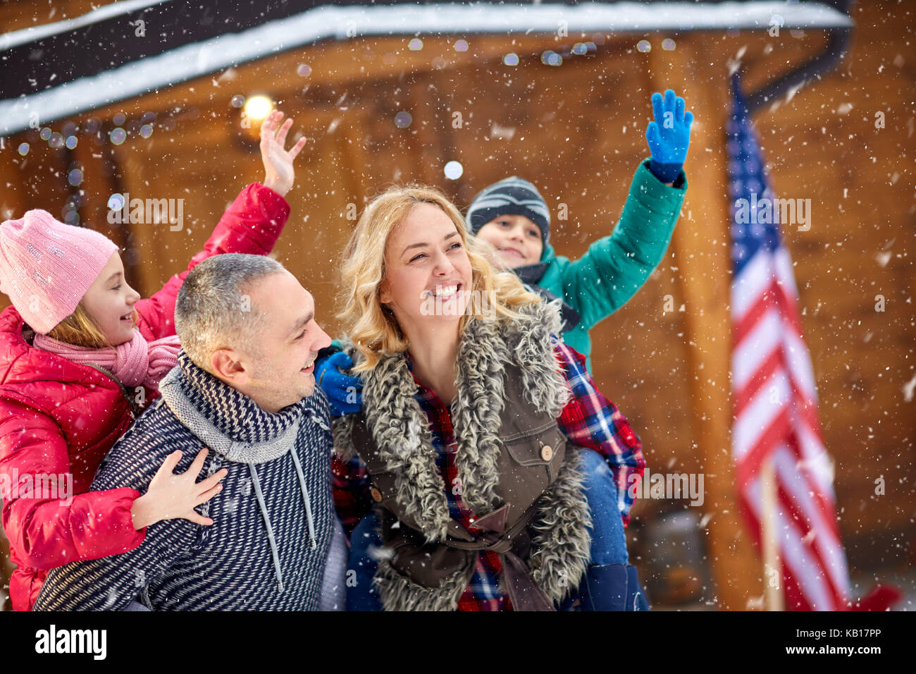 portrait young smiling family enjoying on snowy day Stock Photo - Alamy