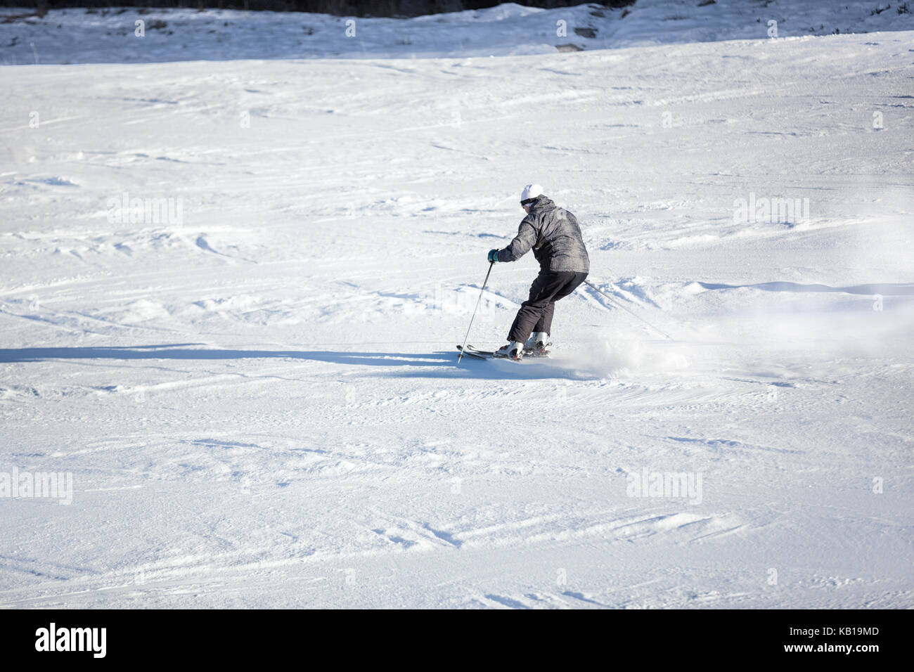 Skier on ski slope in in powder of snow Stock Photo - Alamy