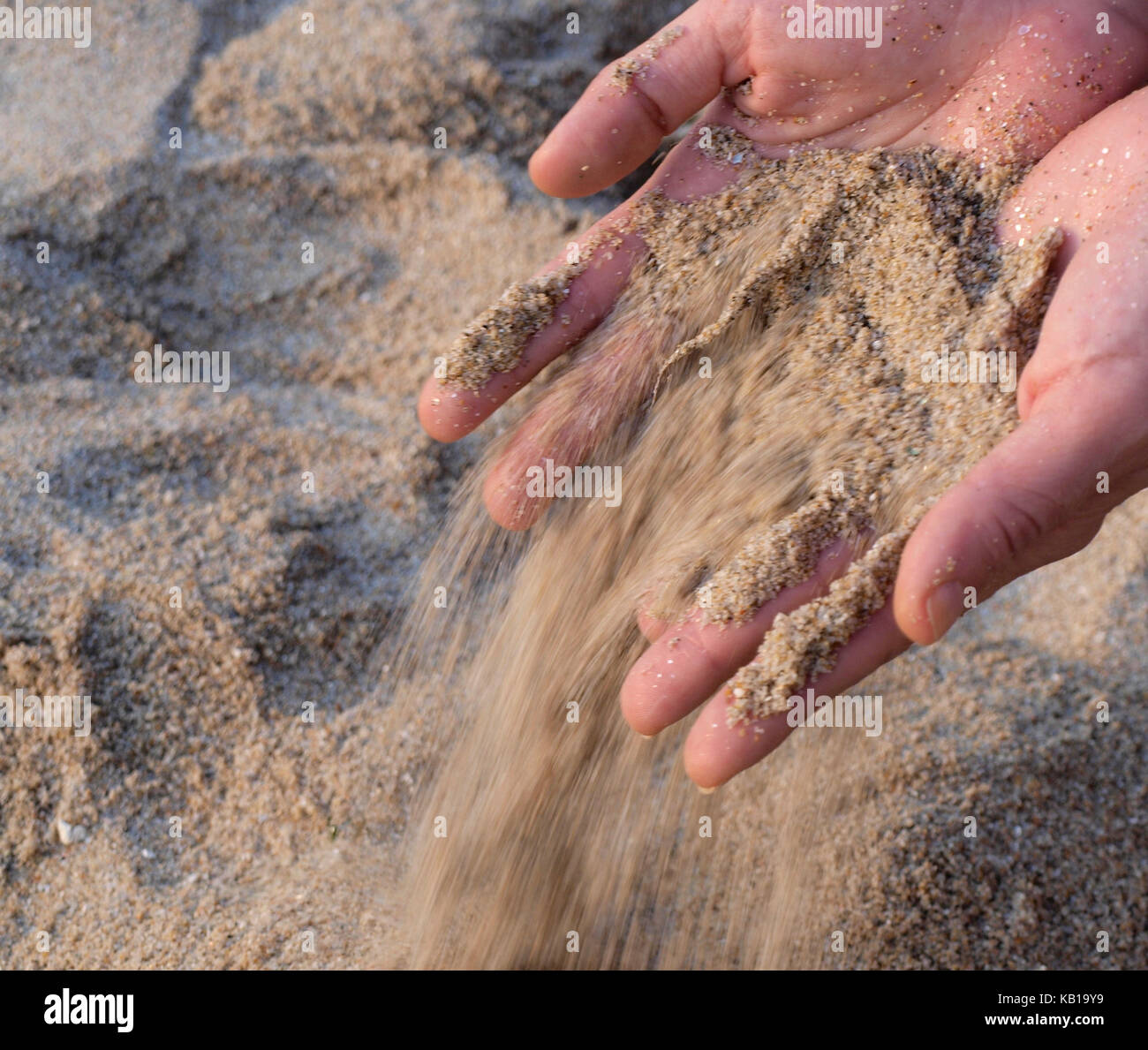 sand falling from hands Stock Photo - Alamy