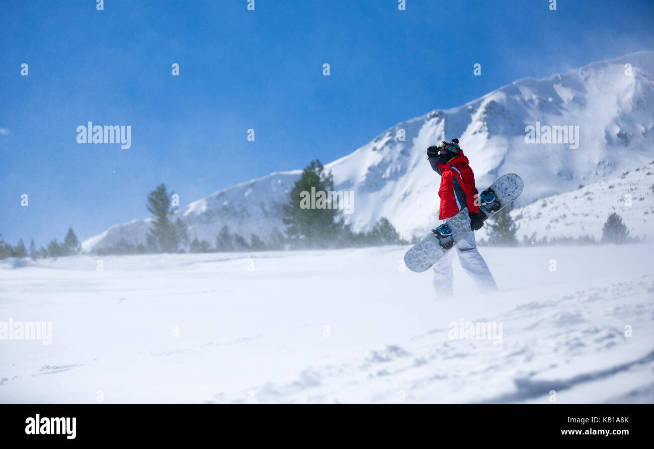 Male snowboarder against panoramic winter mountains background Stock ...
