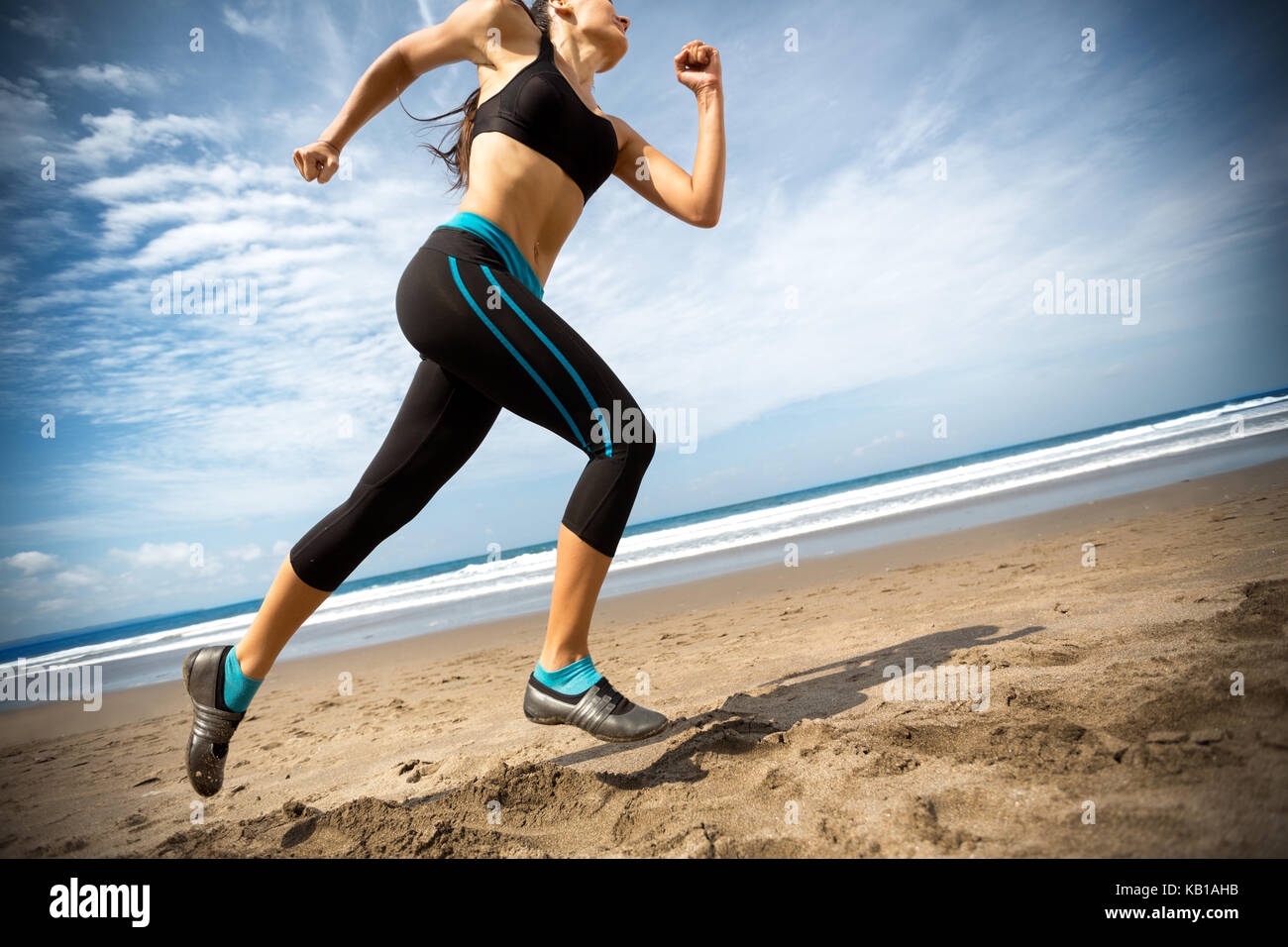 Female running on beach hi-res stock photography and images - Alamy