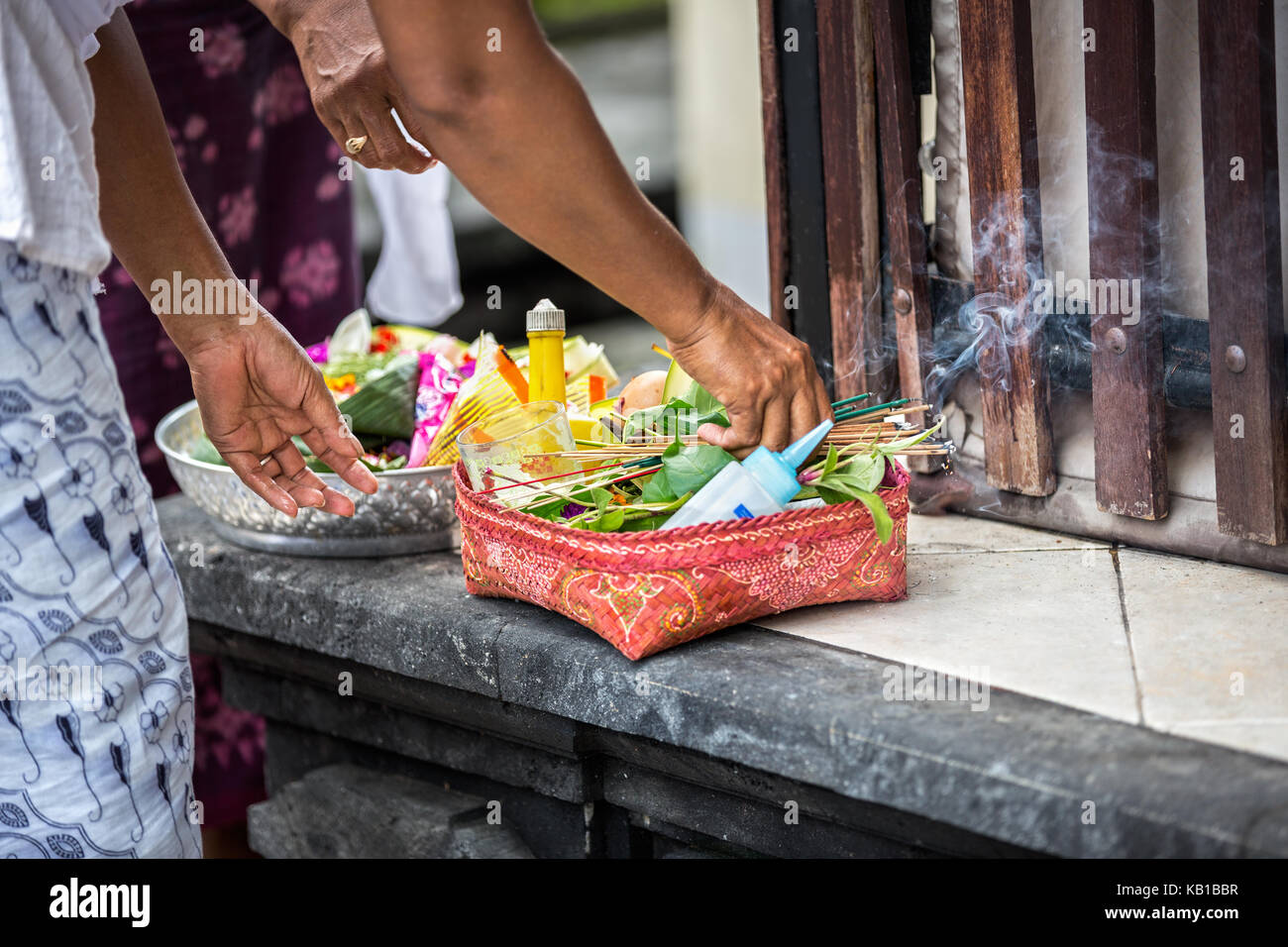 Female hands offering food to God, traditional Balinese offerings to ...