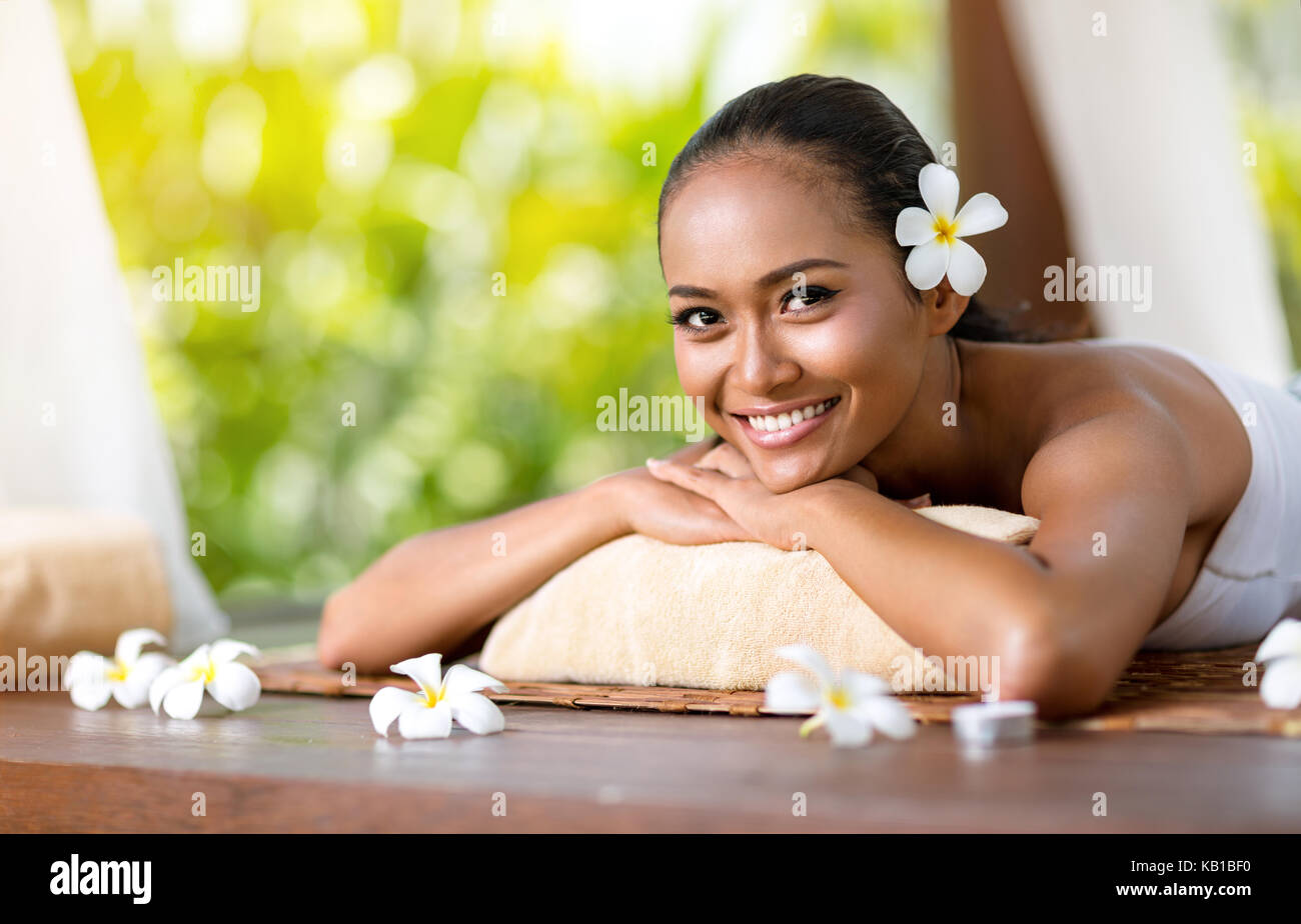 Beautiful smiling woman relaxing under canopies for massage Stock Photo ...